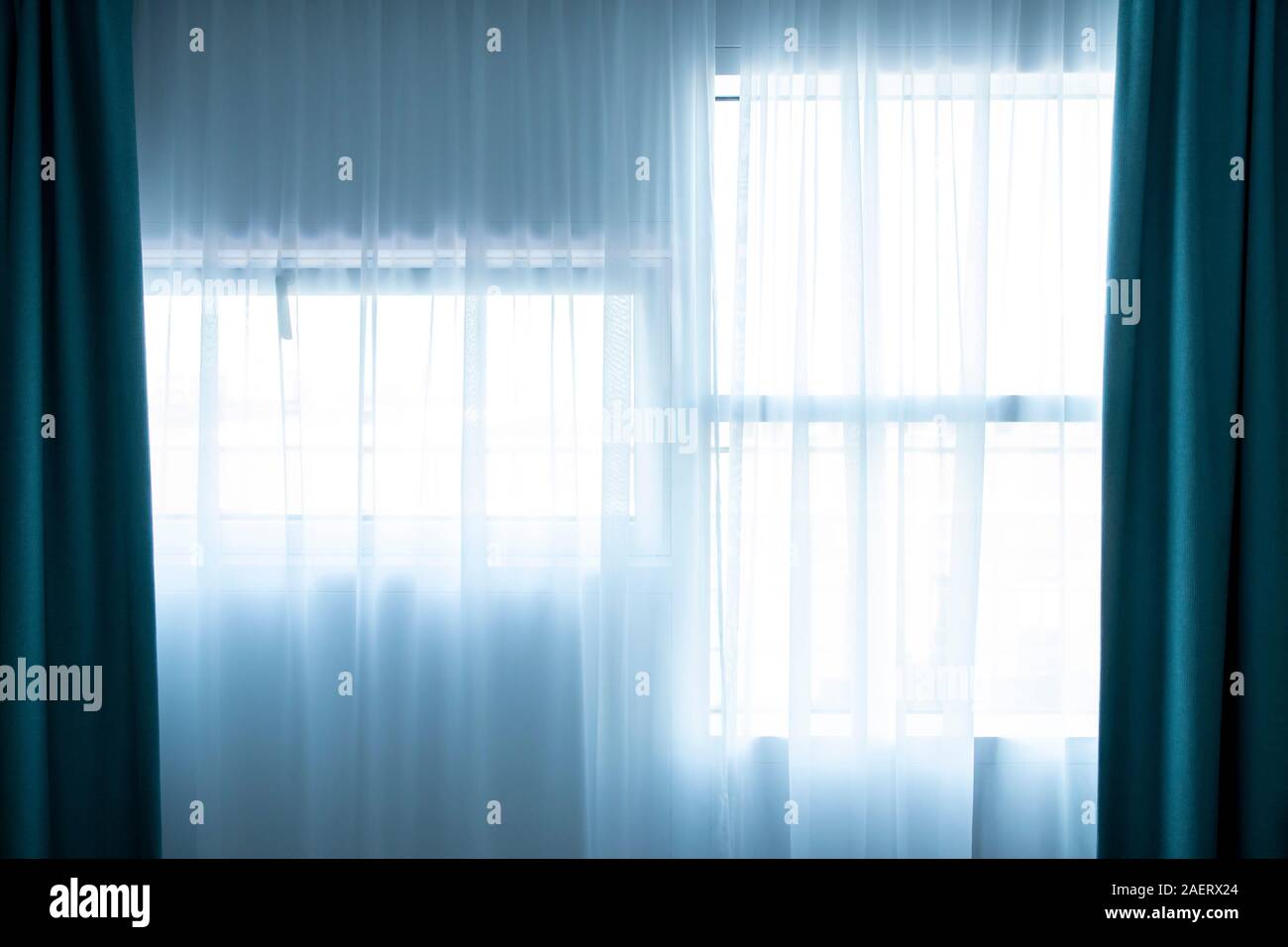 Light falls through windows, with curtains, into a room Stock Photo - Alamy