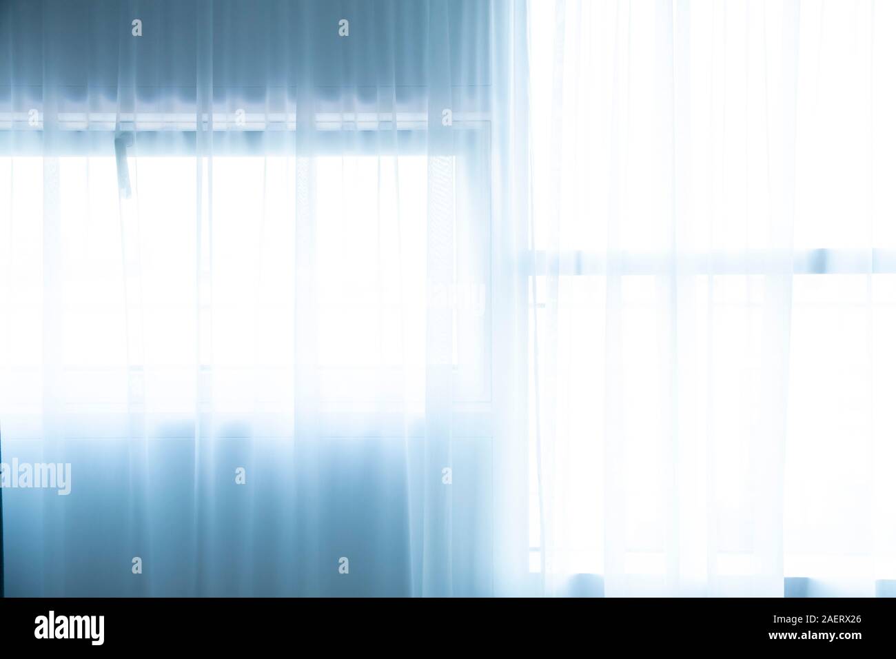 Light falls through windows, with curtains, into a room Stock Photo - Alamy