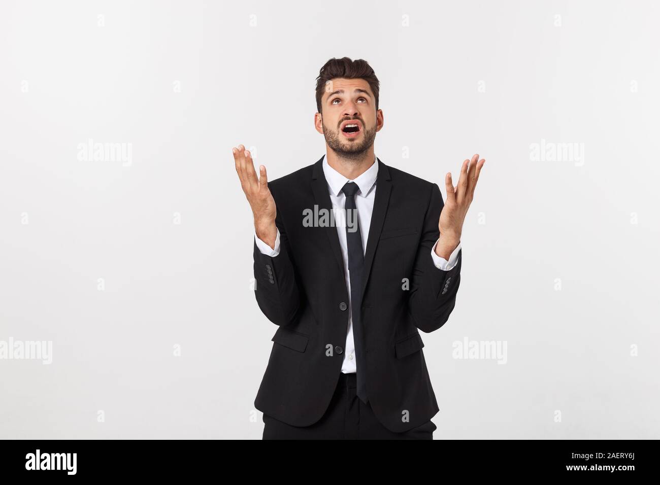 young handsome man shouting aggressively, looking very angry ...