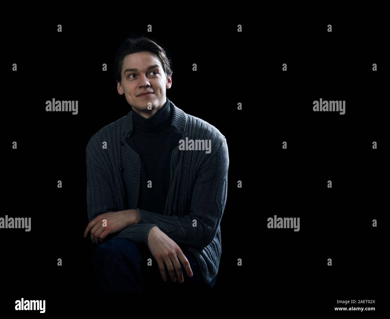 Portrait of a handsome man on a black background. Emotions of ...