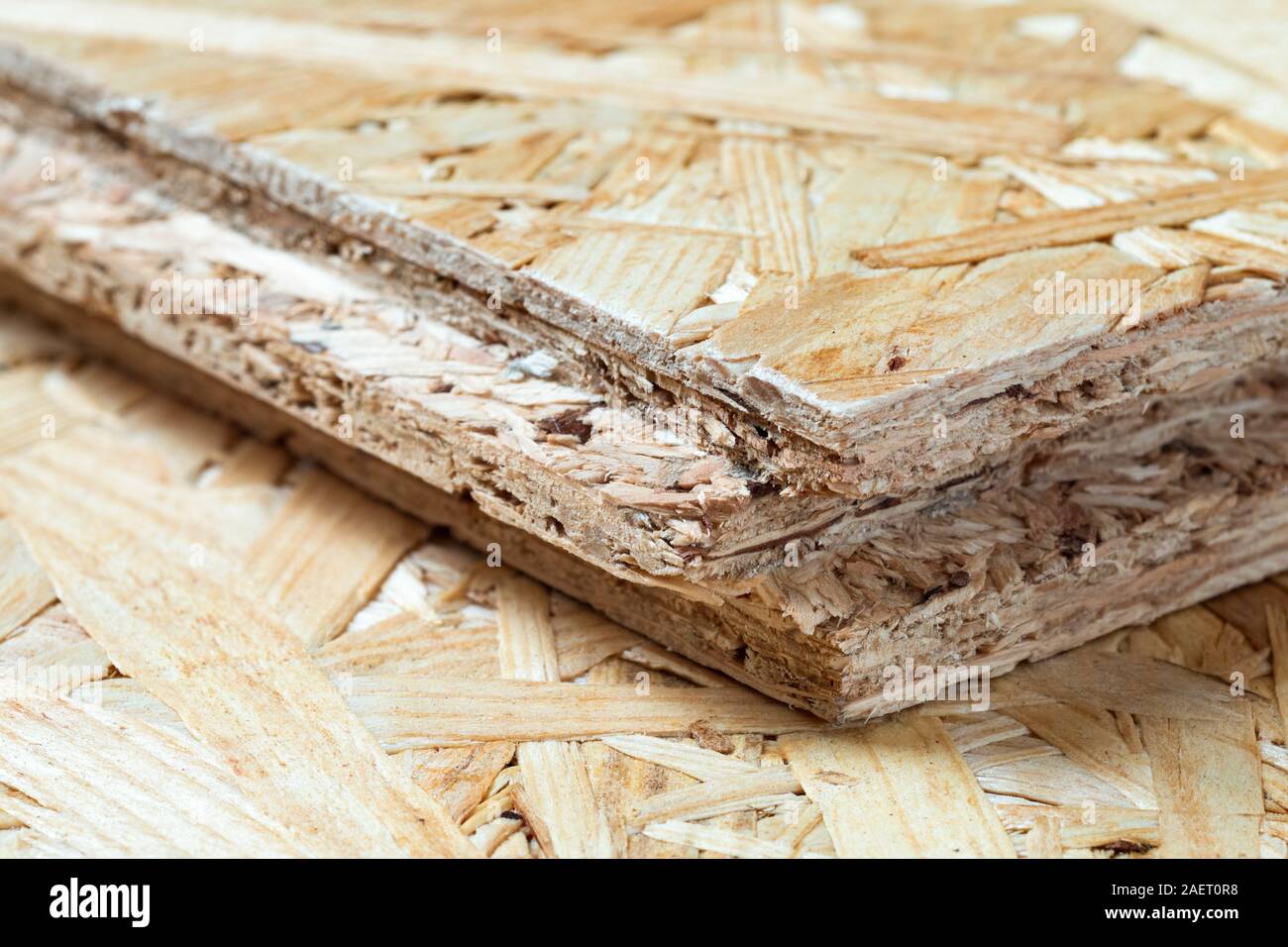 Detail of tongue and groove chip board lying on top of chip board ...