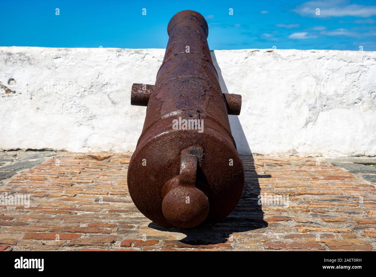 Old rusty cannon from the 16th century inside a tropical coastal fort ...
