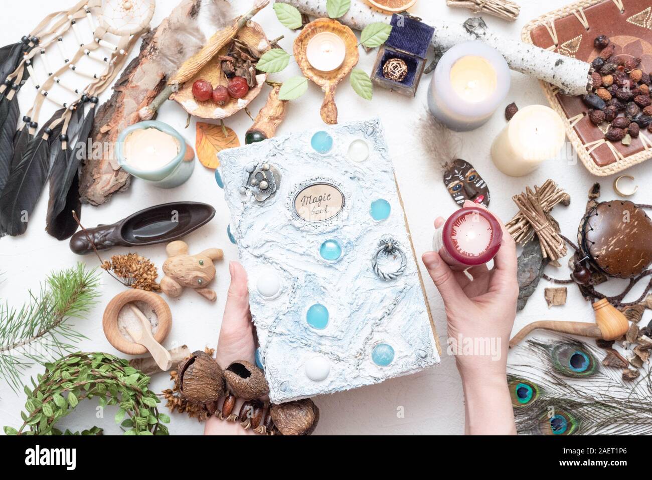 Magic book in woman hands on witch doctor table background concept ...