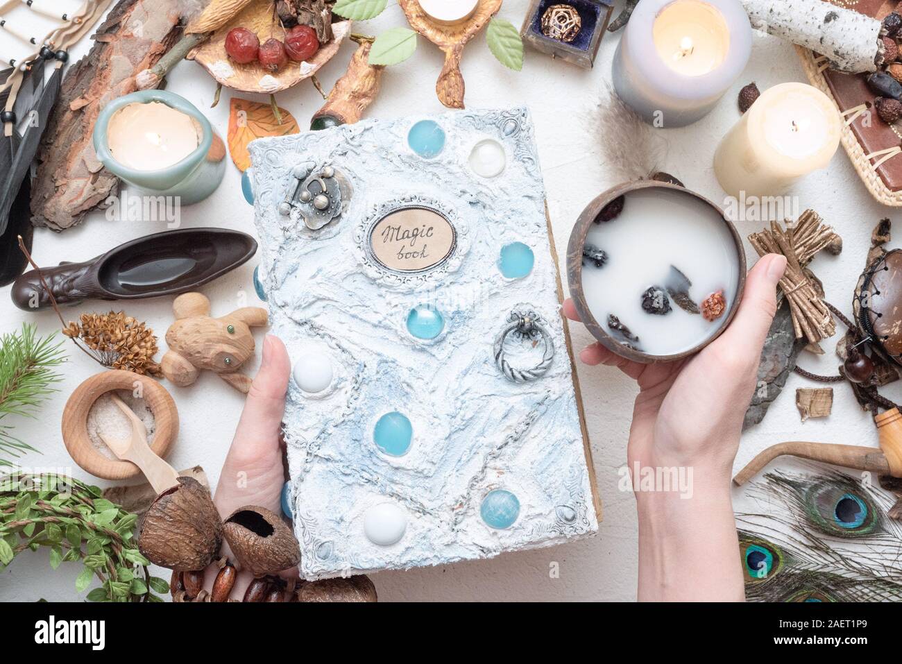 Magic book and goblet with magic potion in woman hands on witch doctor ...