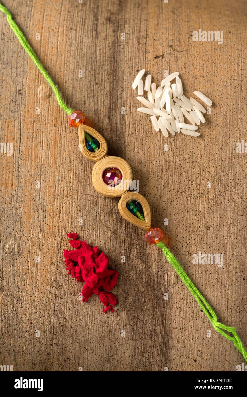 Indian festival: Raksha Bandhan background with an elegant Rakhi, Rice ...