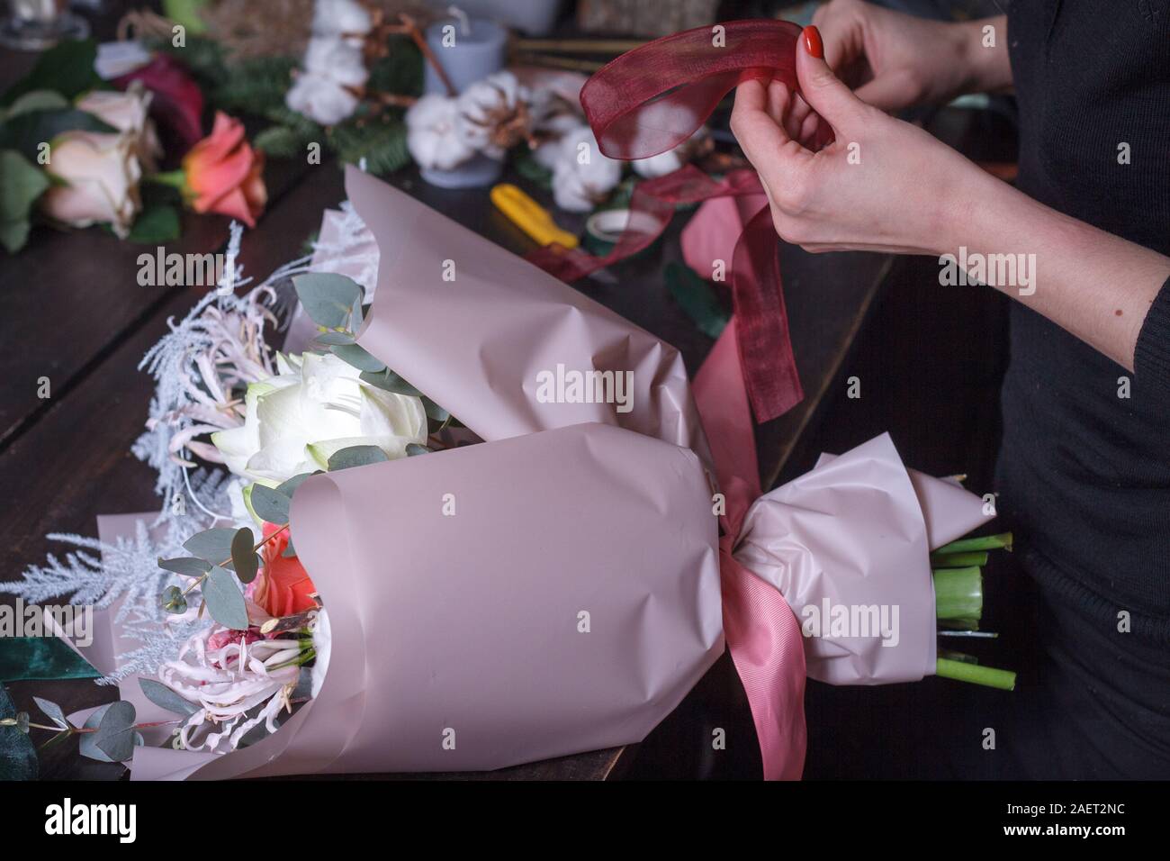 Woman florist makes a bouquet to order, concept of own flower business, selective focus Stock ...