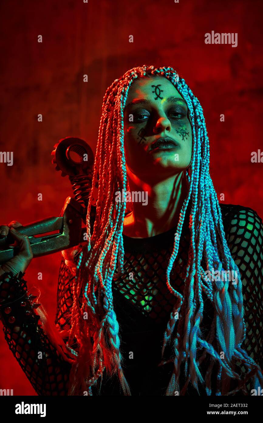 brutal girl with dreadlocks and wrench with creative make up. Halloween ...