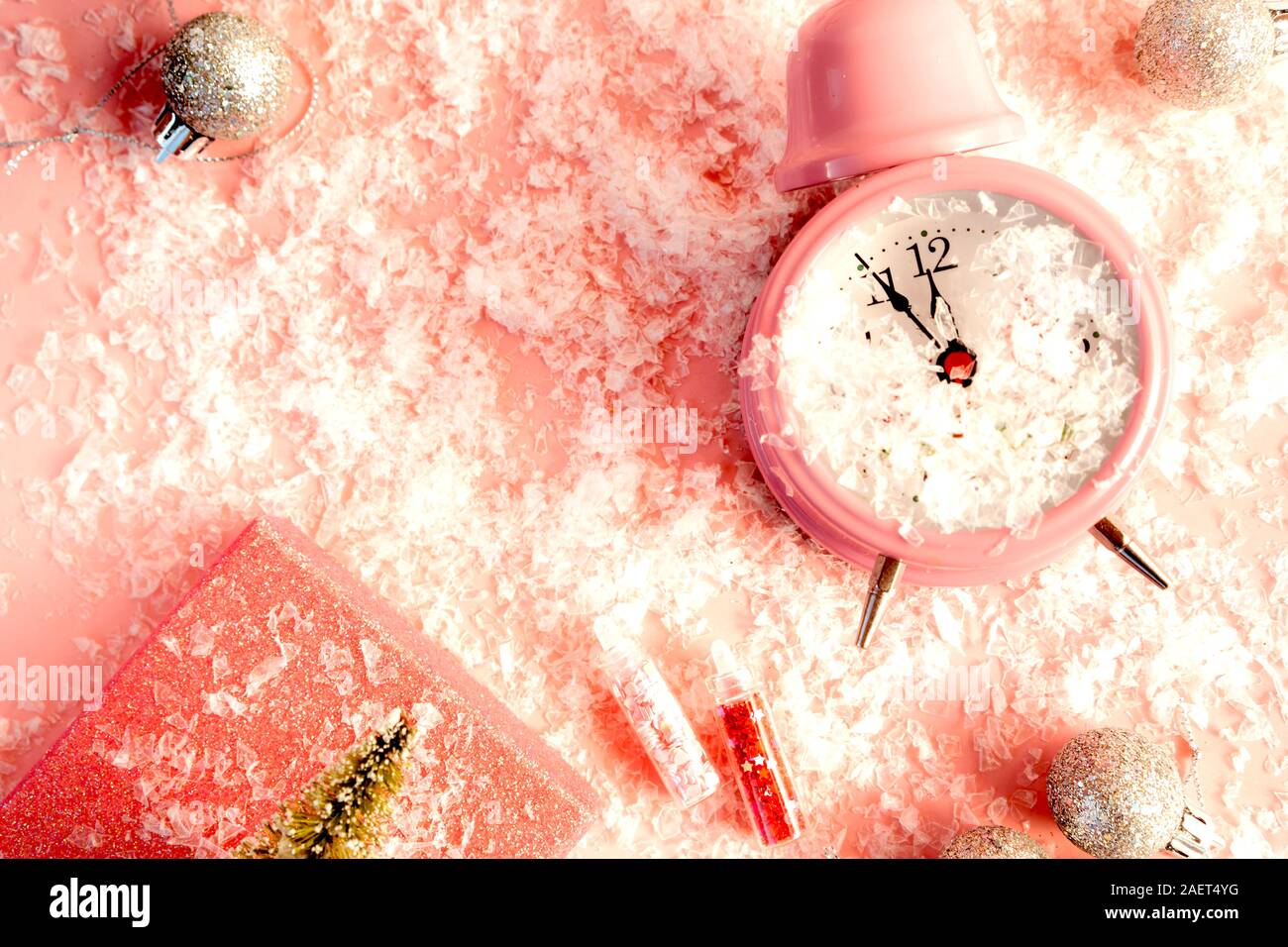 Pastel pink alarm clock at five minutes to midnight Stock Photo - Alamy