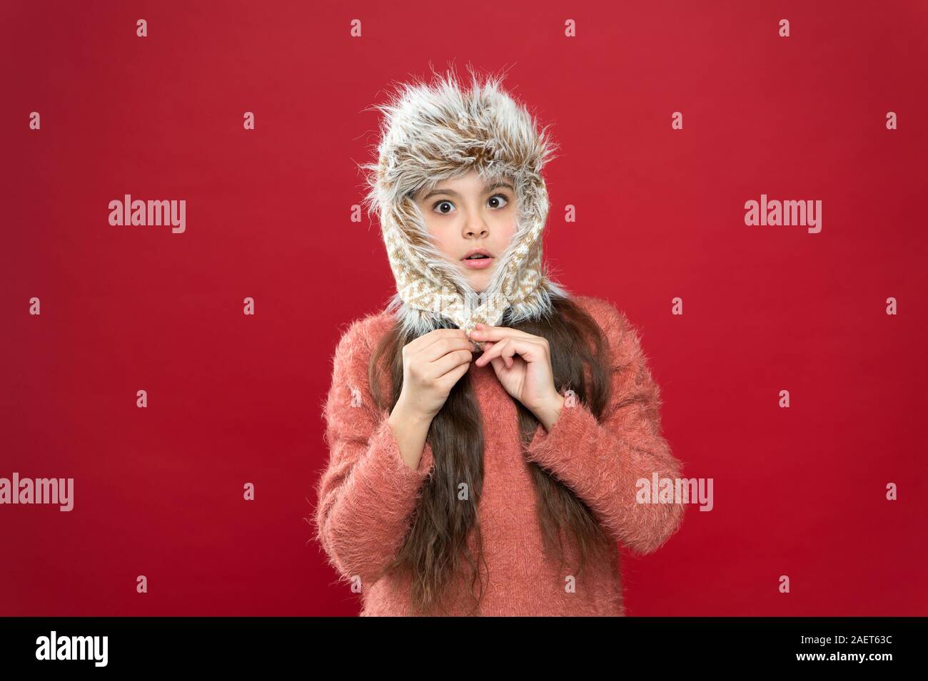 cold little girl in earflap hat. warm kid fashion. holiday activity ...