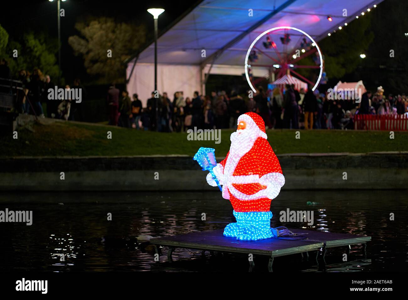 An illuminated Father Christmas figure stands in the middle of a small ...