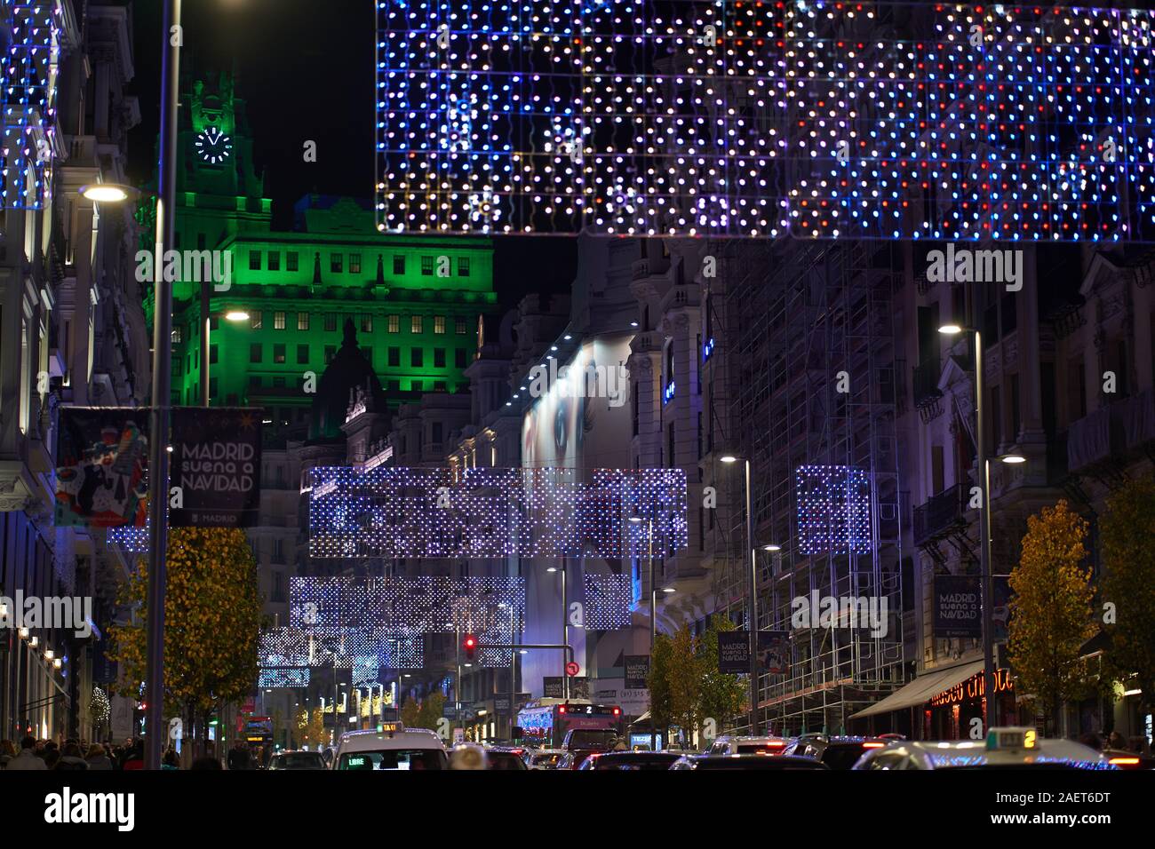 A view along a busy Gran Via in Madrid illuminated with Christmas ...