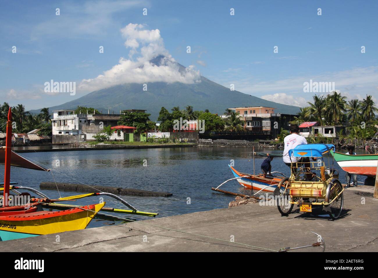 Mayon volcano looming over Tabaco city’s harbour, Luzon island, The ...