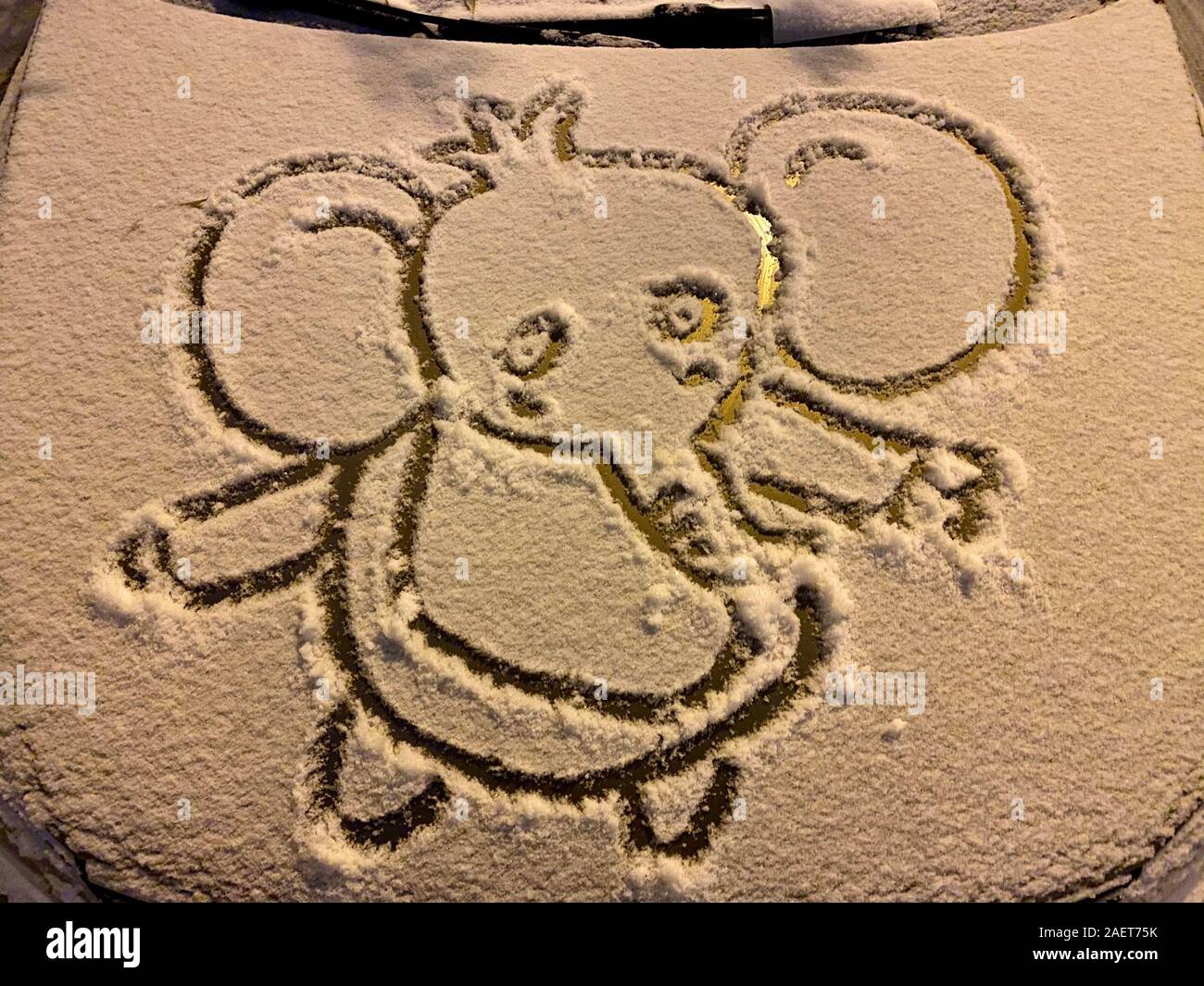Cartoon characters are drawn on hood with snow as first snowfall visits ...
