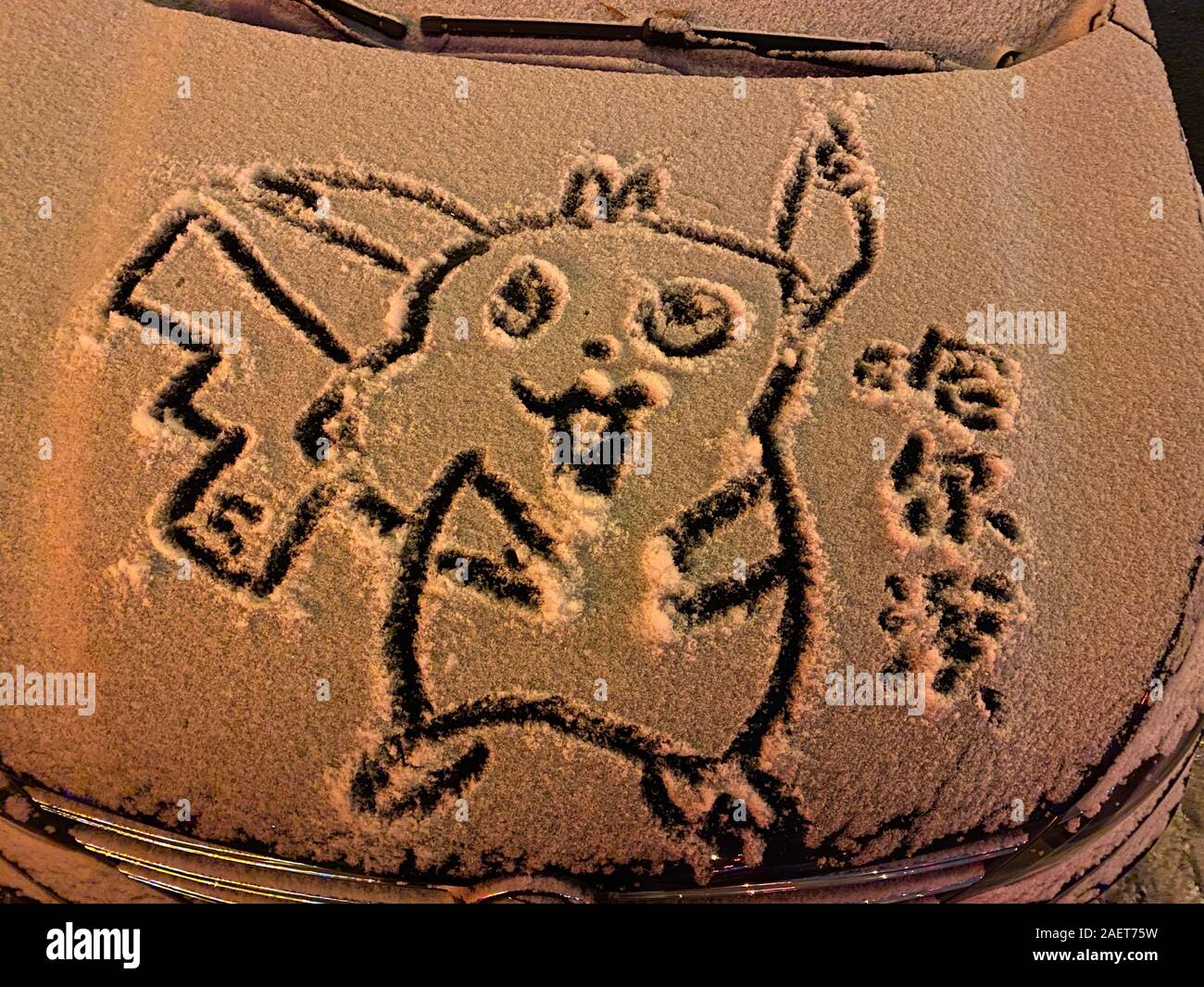 Cartoon characters are drawn on hood with snow as first snowfall visits ...