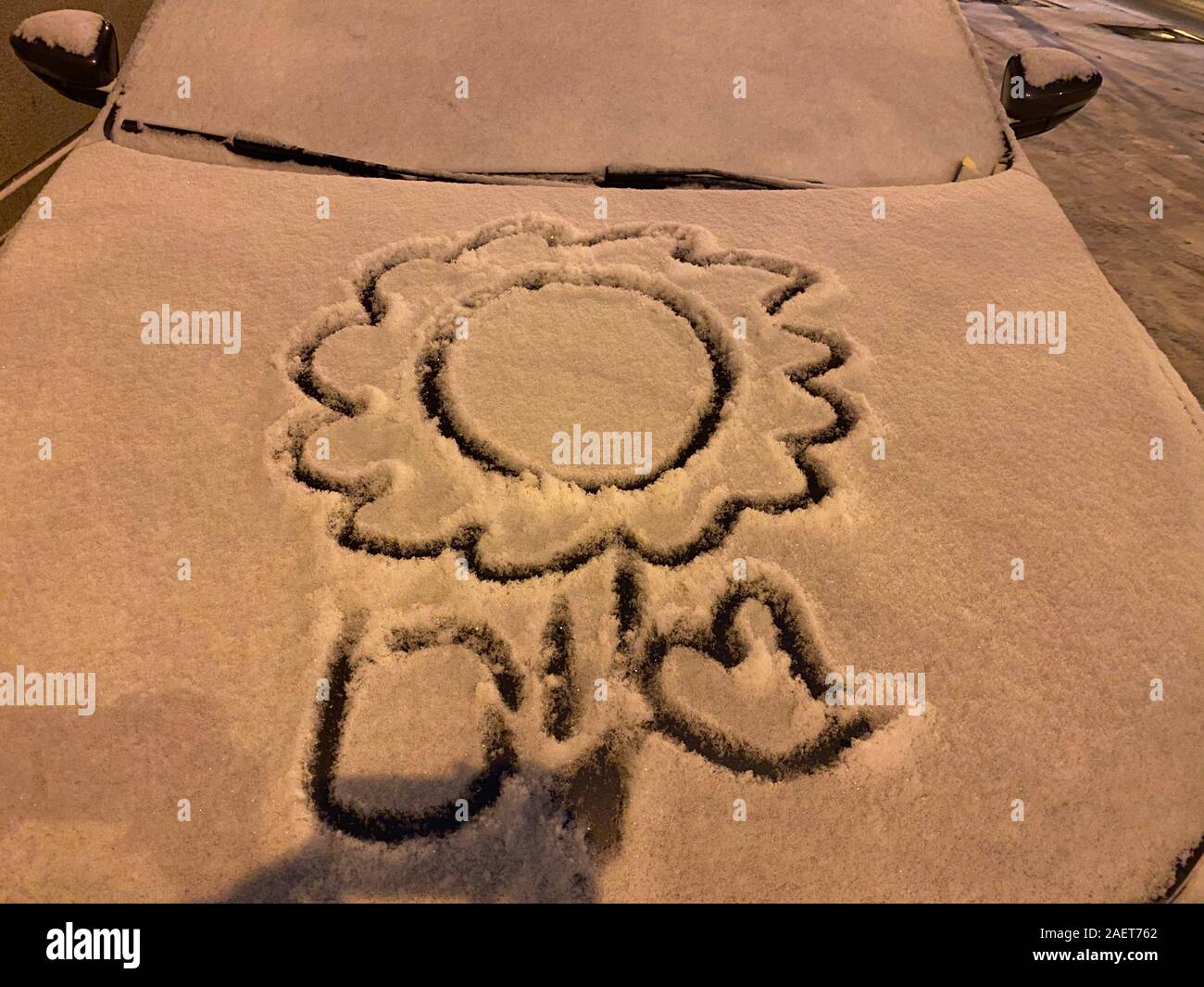 Cartoon characters are drawn on hood with snow as first snowfall visits ...