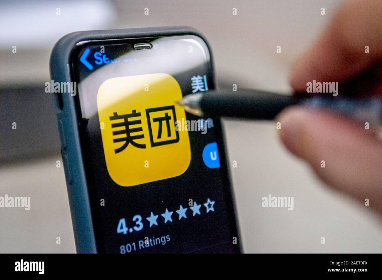 --FILE--In this unlocated photo, a user downloads Meituan's App on his ...