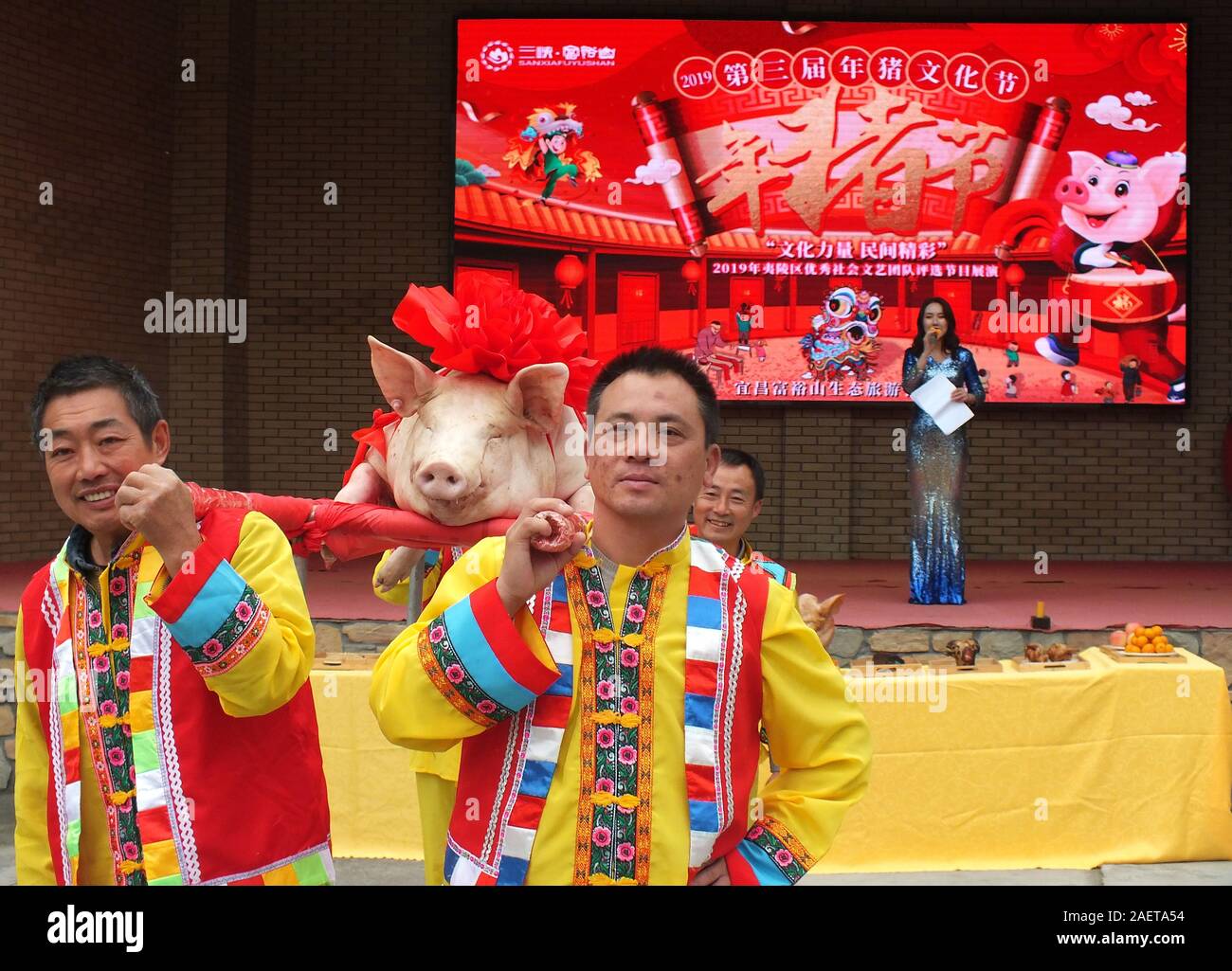 People carry a pig with a sedan chair for the pig sacrifice section at ...