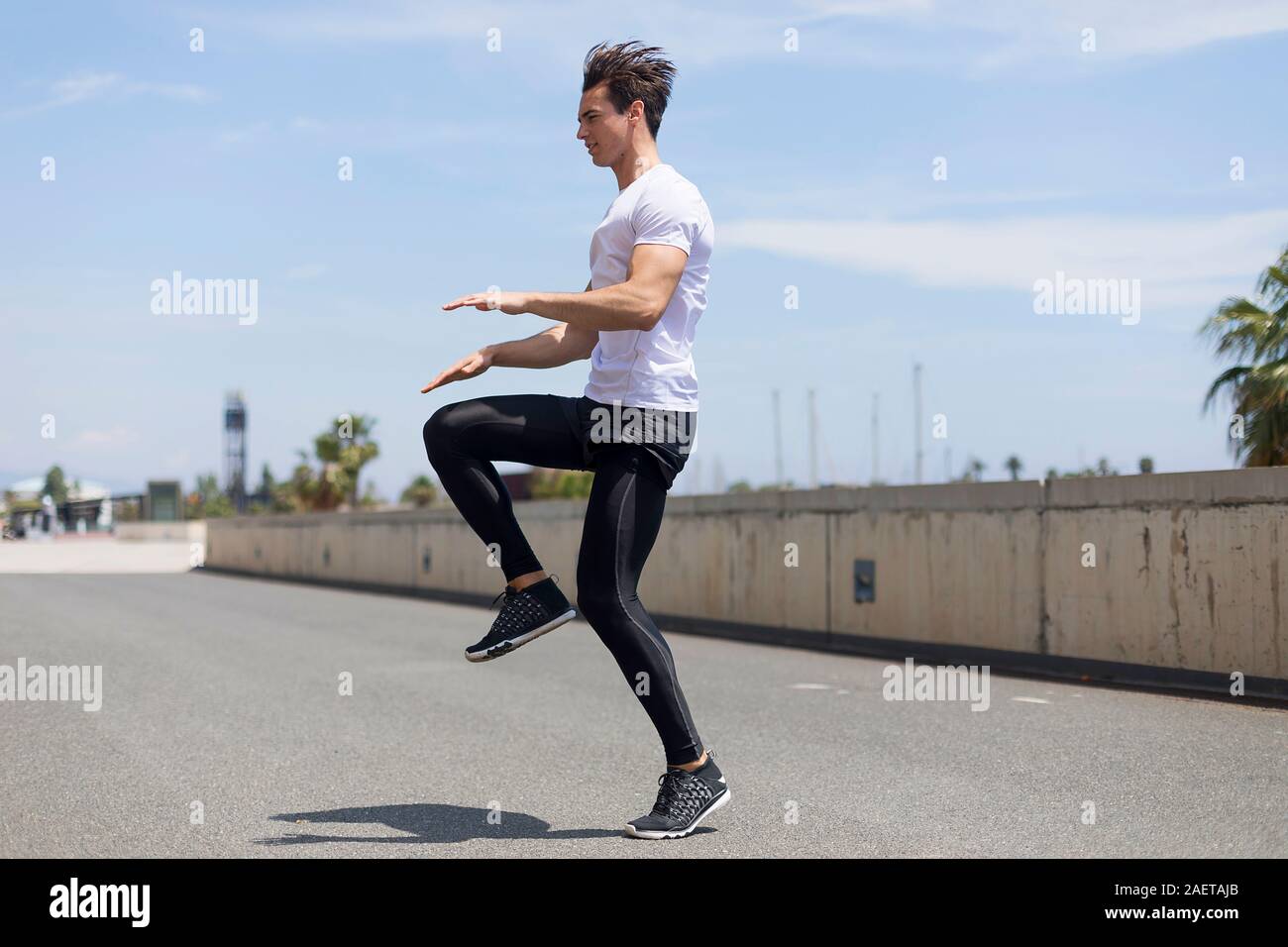 Happy man and jumping outdoors, warmup before jogging Stock Photo - Alamy