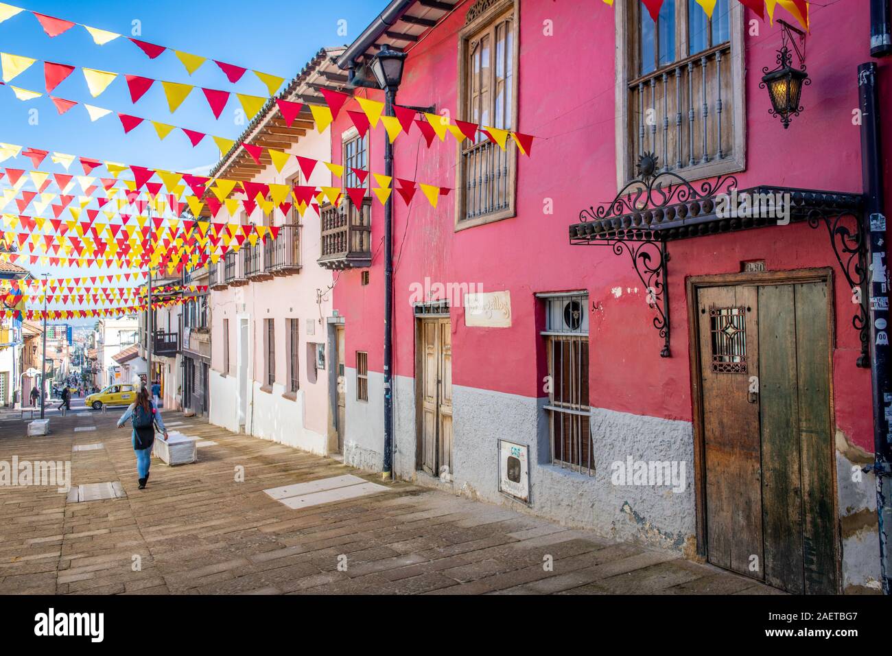 Flags in the color of the Bogot‡ flag hang over the street , Bogot ...