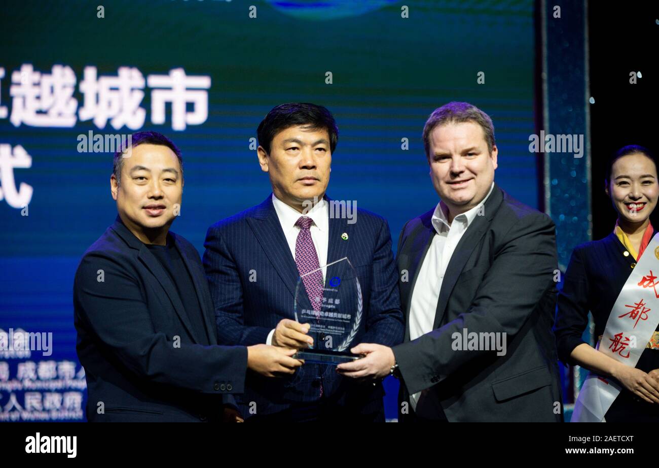 Liu Guoliang, left, and other representatives hold a plate at the ...