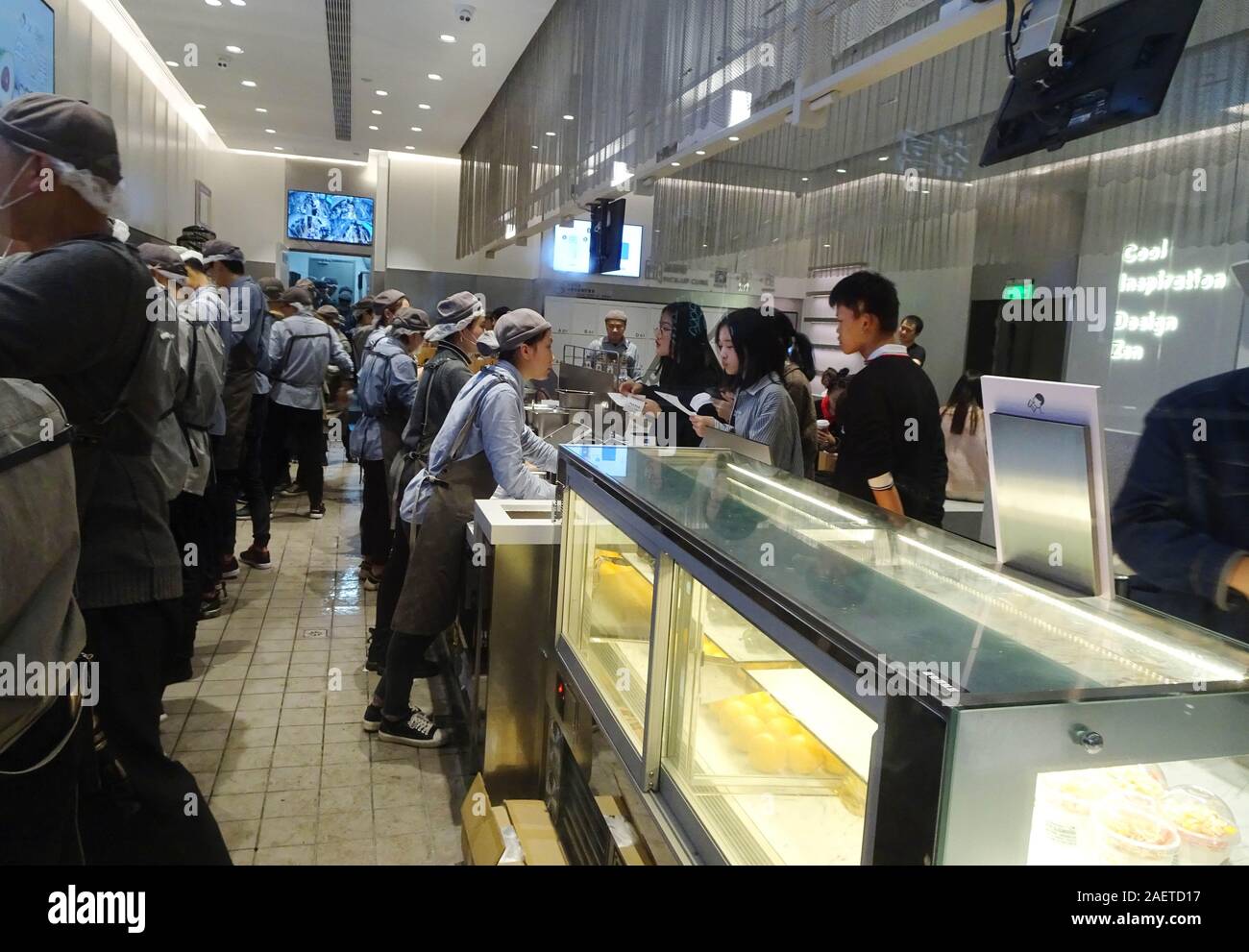 Staff prepares milk tea ordered by a large number of customers lining ...