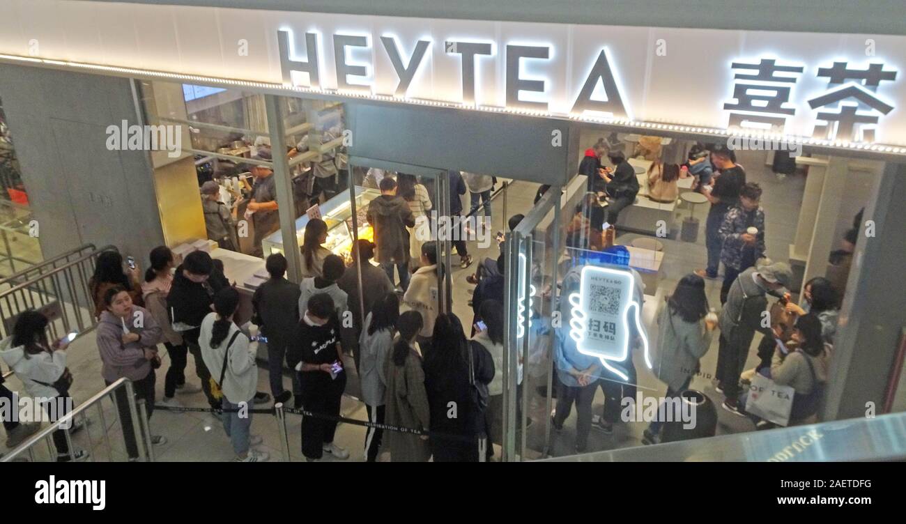 Local citizens, especially the youth, form a long line to buy milk tea ...