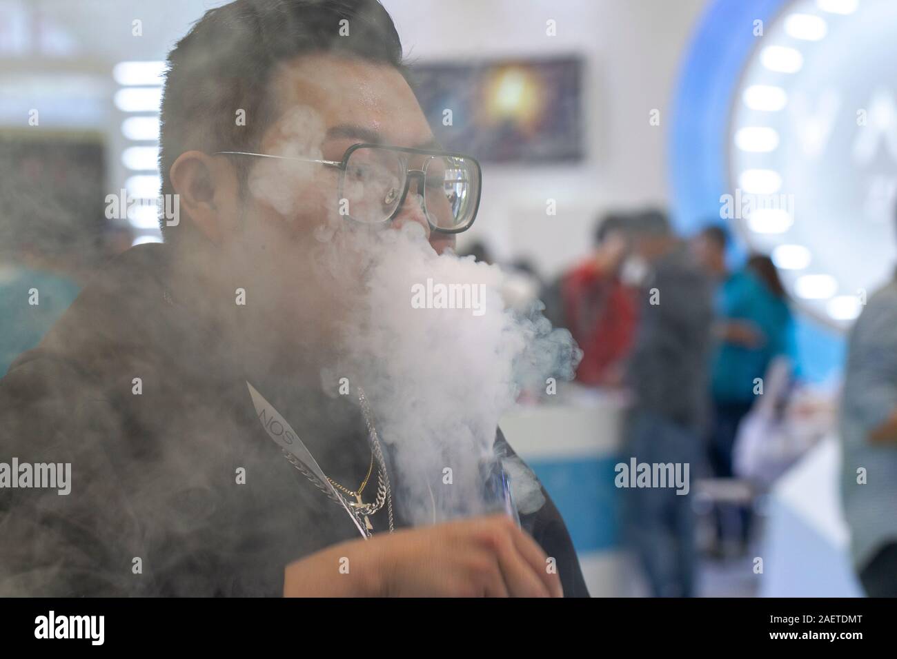 A person vapes at the 2019 Vape Culture Week and IECIE eCig Expo in ...
