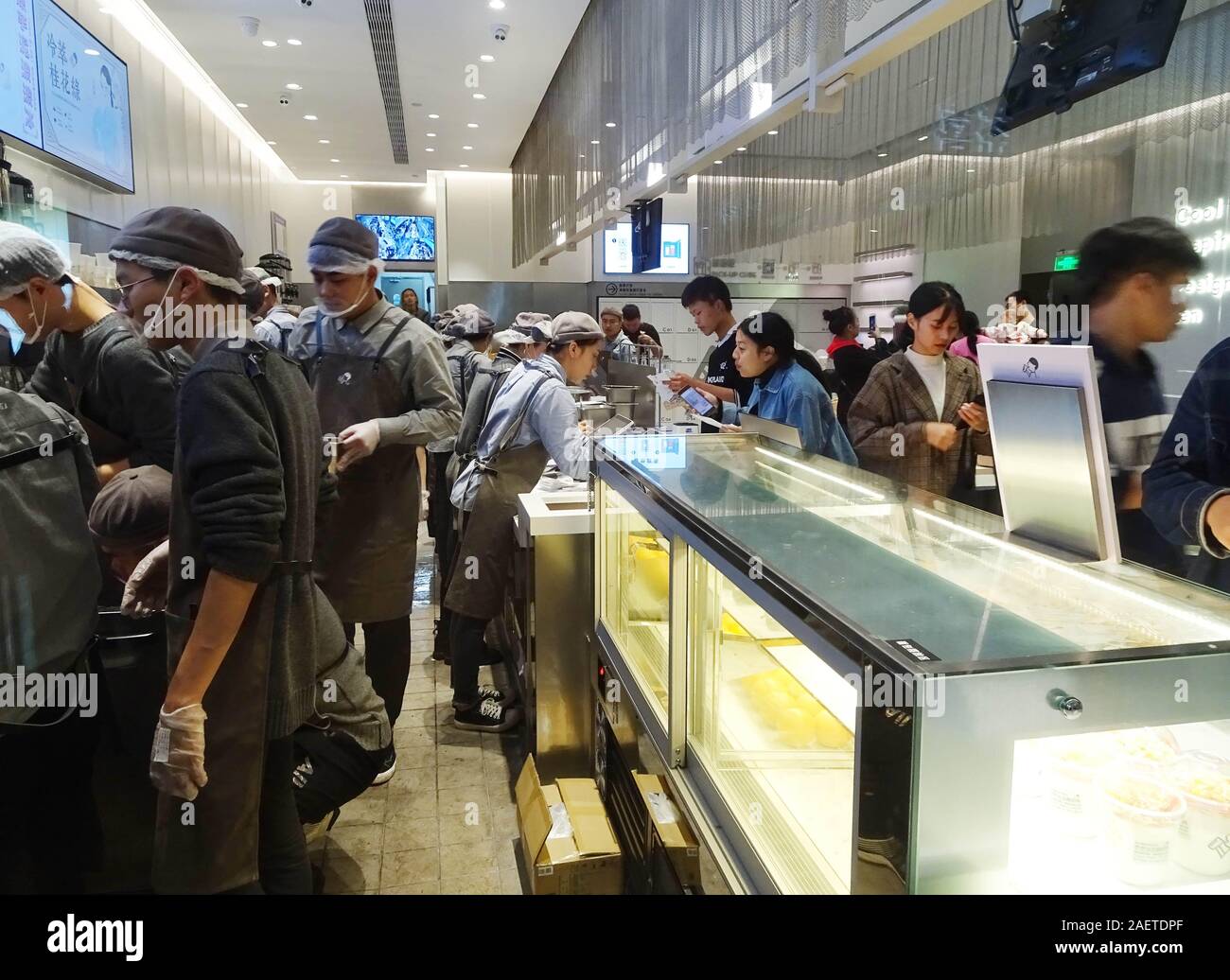 Staff prepares milk tea ordered by a large number of customers lining ...