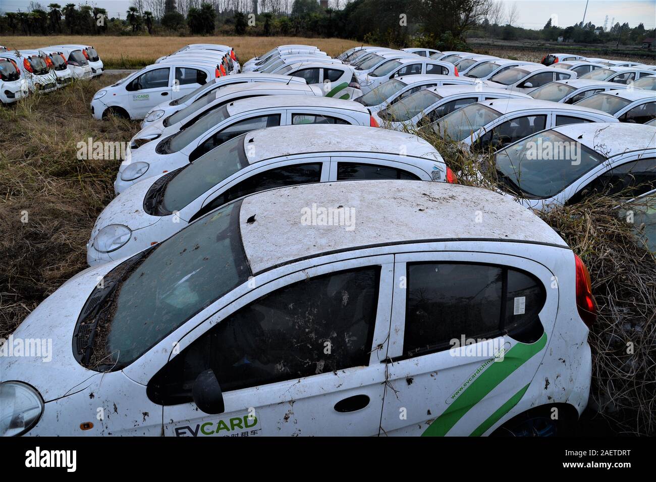 Abandoned shared electric vehicles line up at a field in Jiaxing city ...