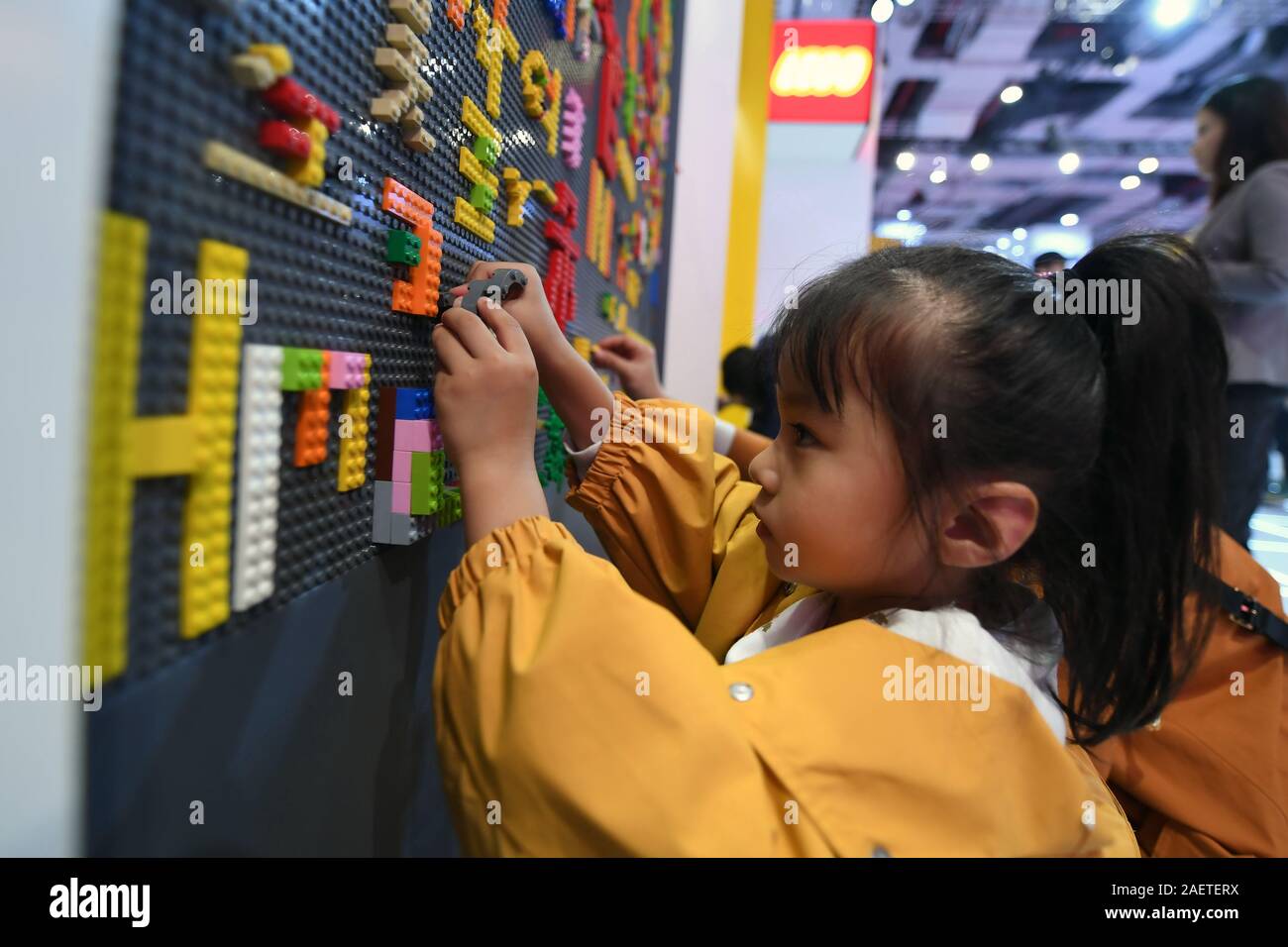 A kid creates characters at the Lego booth at the 2nd China ...