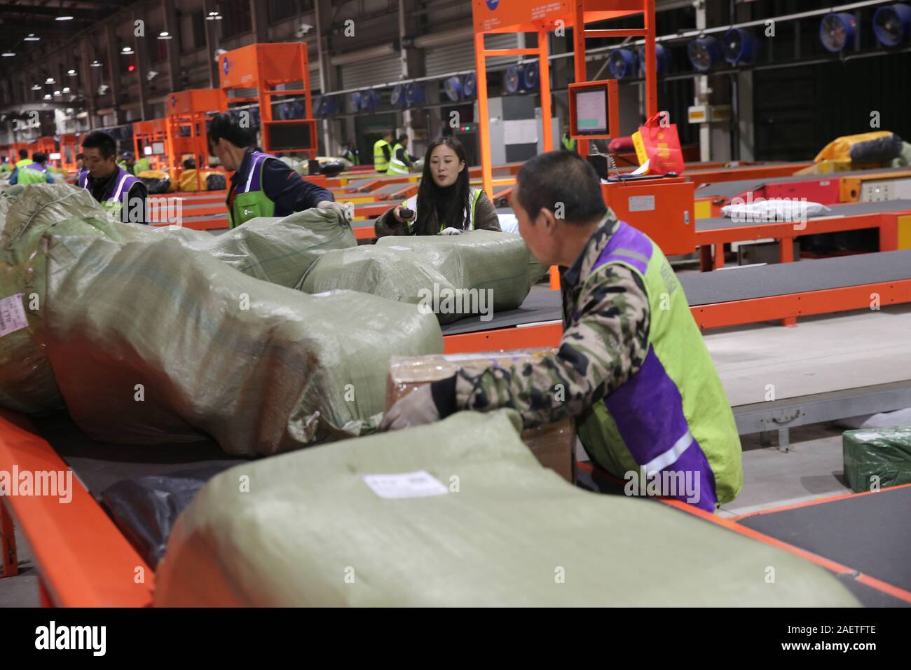 Staff at a logistics center of YT Express, a major express company in ...