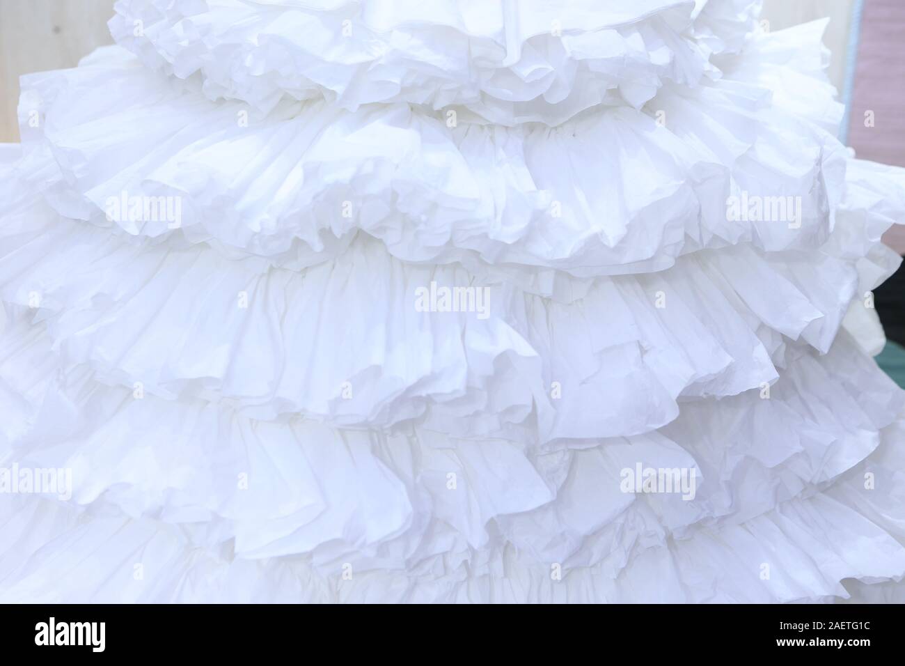 A purely wide wedding dress made of tissue paper is exhibited at a ...