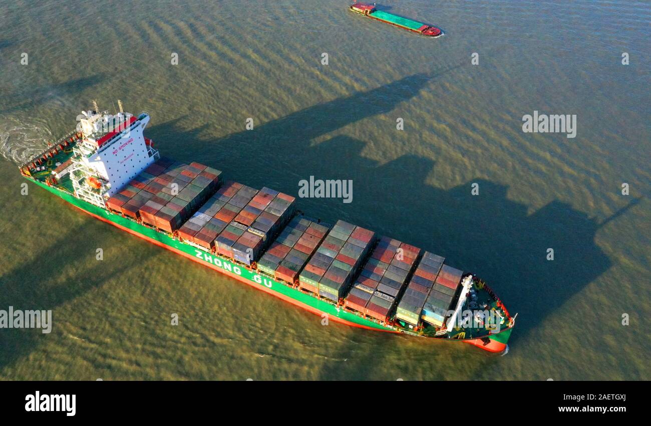 An aerial view of a freighter carrying containers departing from the ...