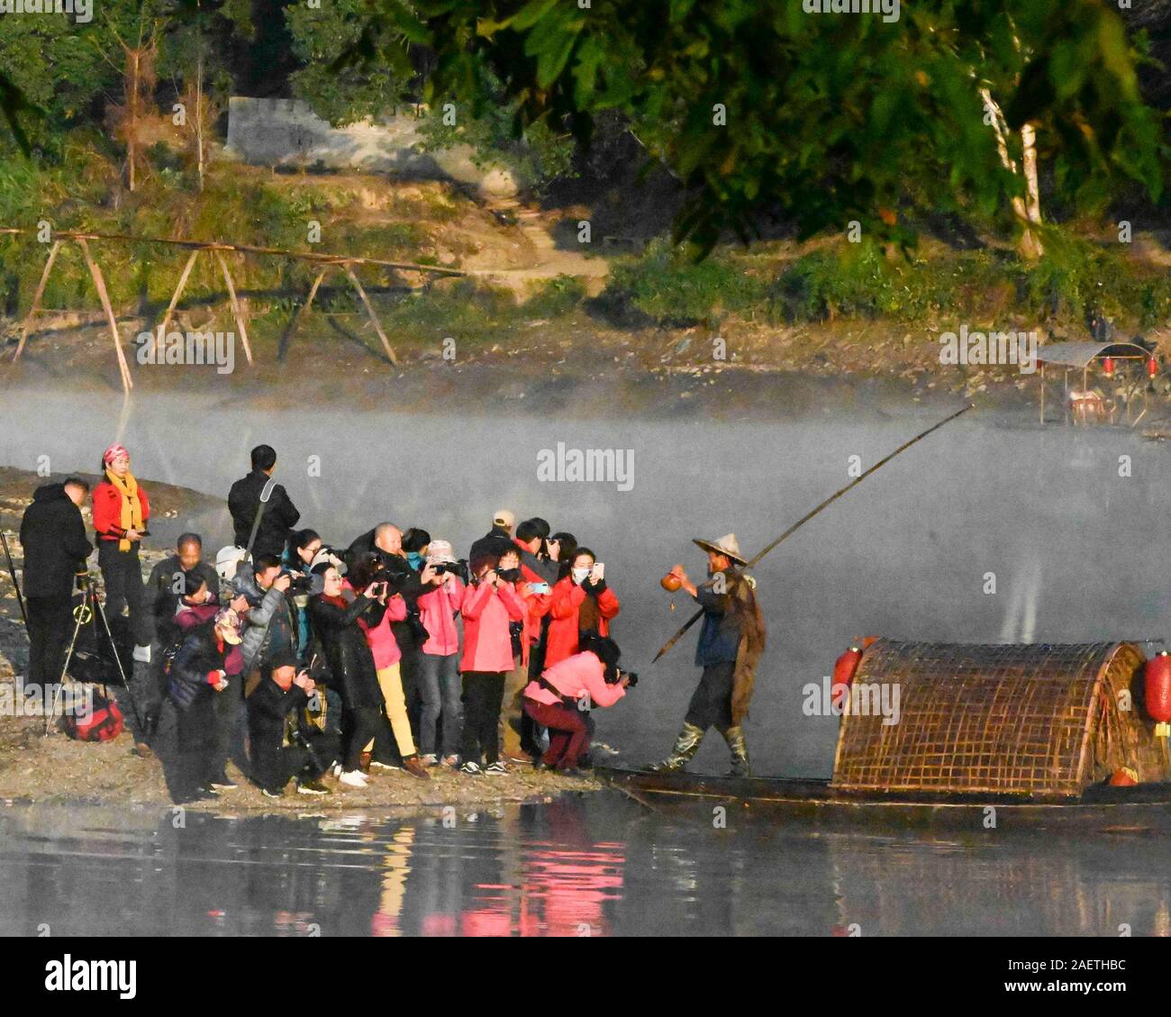 Photographers take photos while Wang Libao, the ex-fisherman and ...