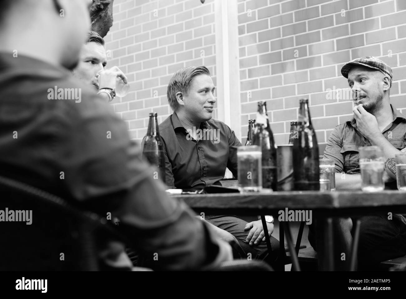Group of men hanging out and relaxing together in the backyard Stock ...