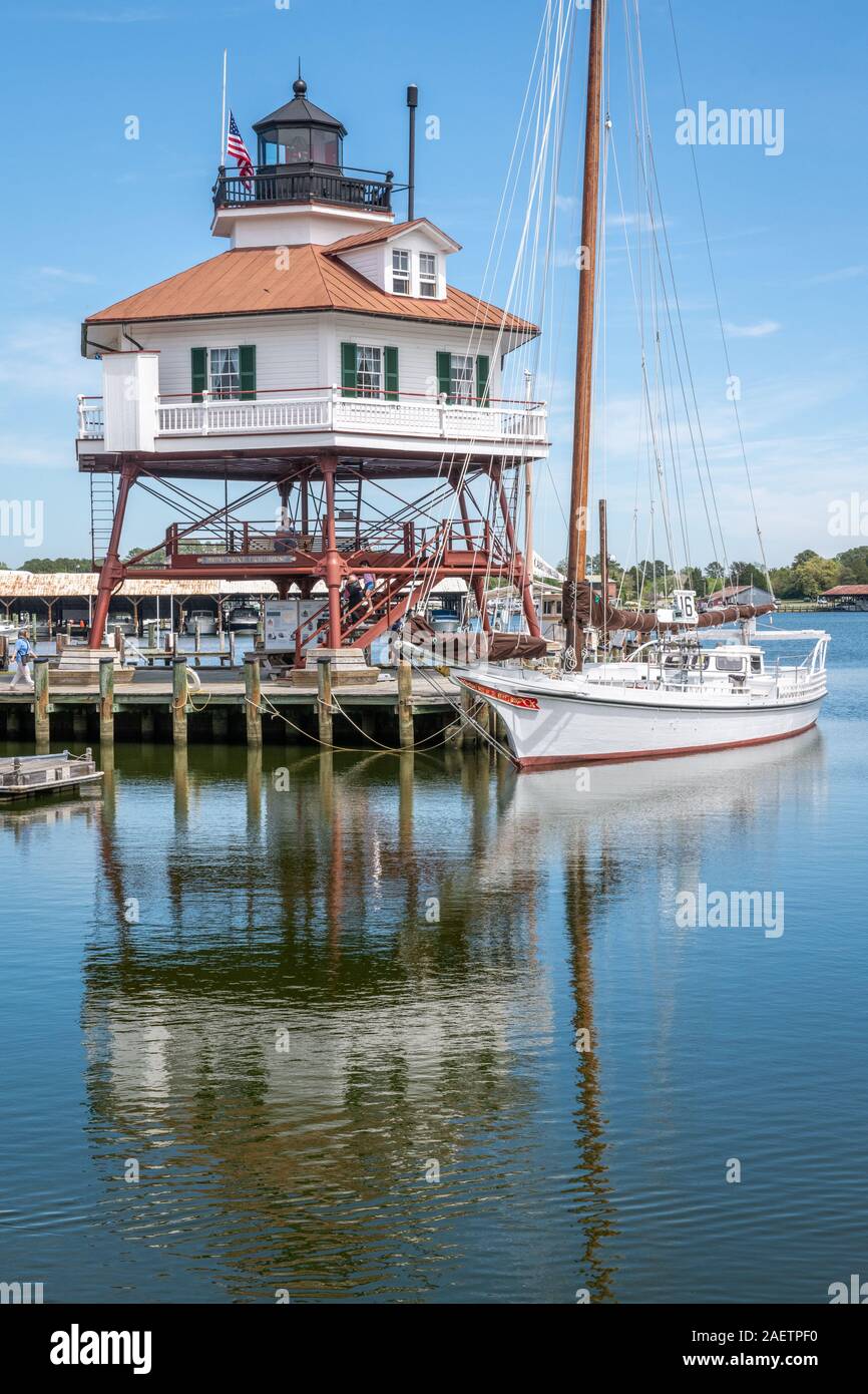 The Drum Point Lighthouse and a boat along the dock of the Calvert ...