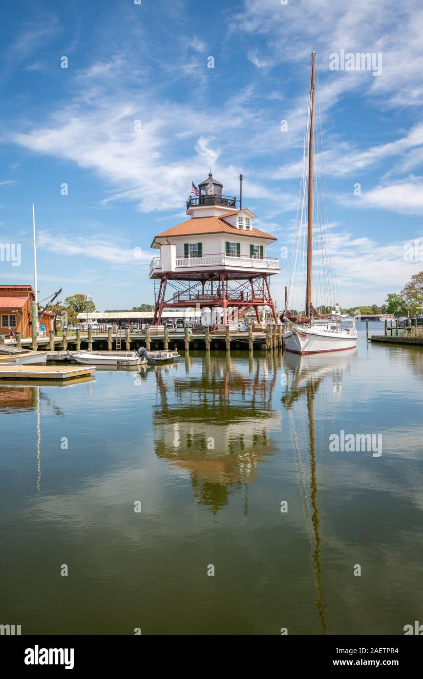 The Drum Point Lighthouse and a boat along the dock of the Calvert ...