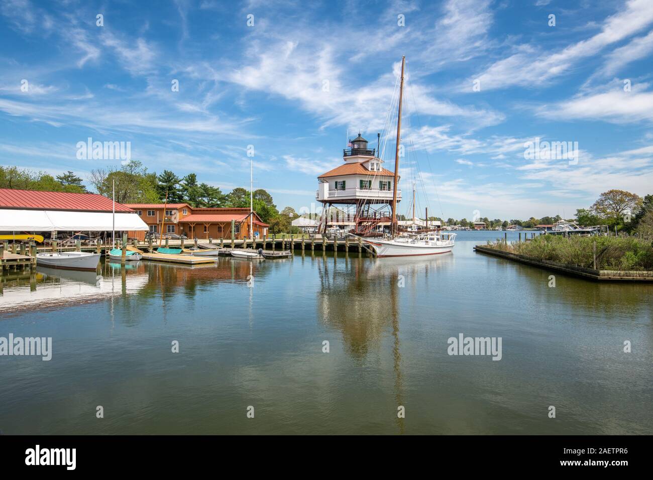 The Drum Point Lighthouse and a boat along the dock of the Calvert ...