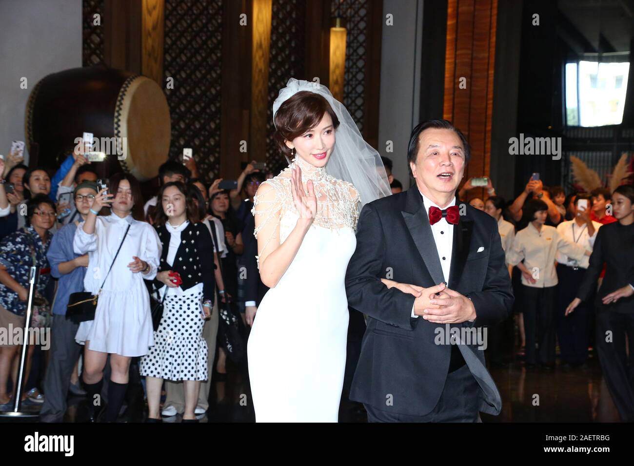 Taiwanese model and actress Lin Chi-ling, middle left, holds hand of ...