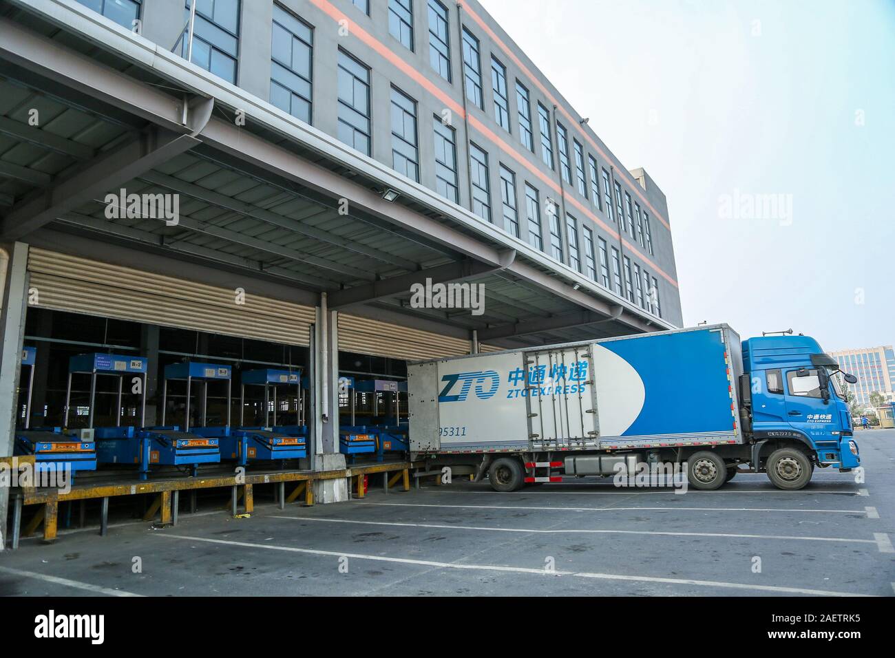 A ZTO Express truck loaded with goods drives out of the plant, central ...