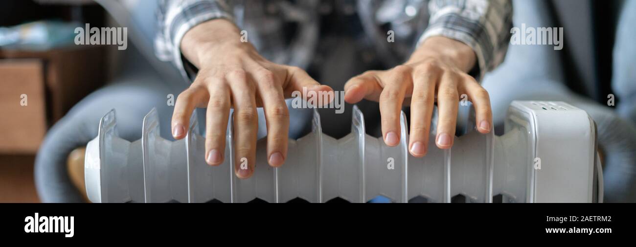 feeling cold, getting warm, hands touching heater close up Stock Photo ...