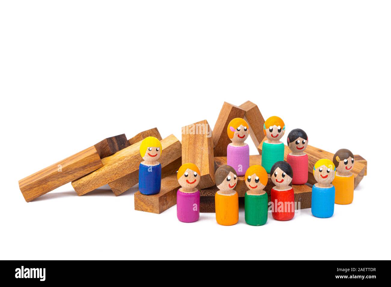 wooden eco-toys standing on different levels of wooden steps on a white ...