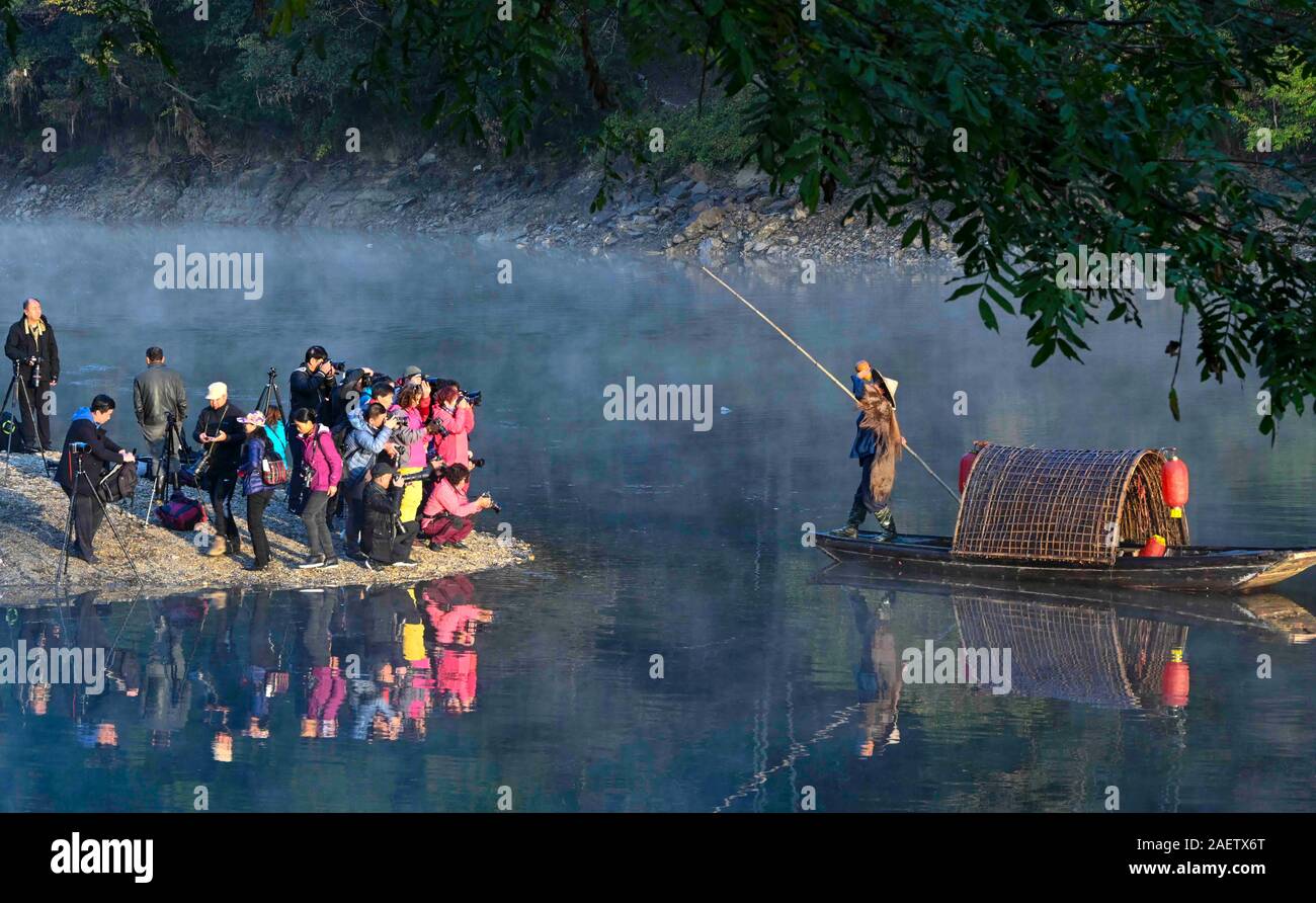 Photographers take photos while Wang Libao, the ex-fisherman and ...