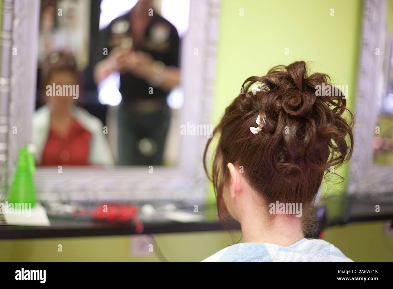 Hairdresser doing a woman's hair in professional hairdressing salon or ...