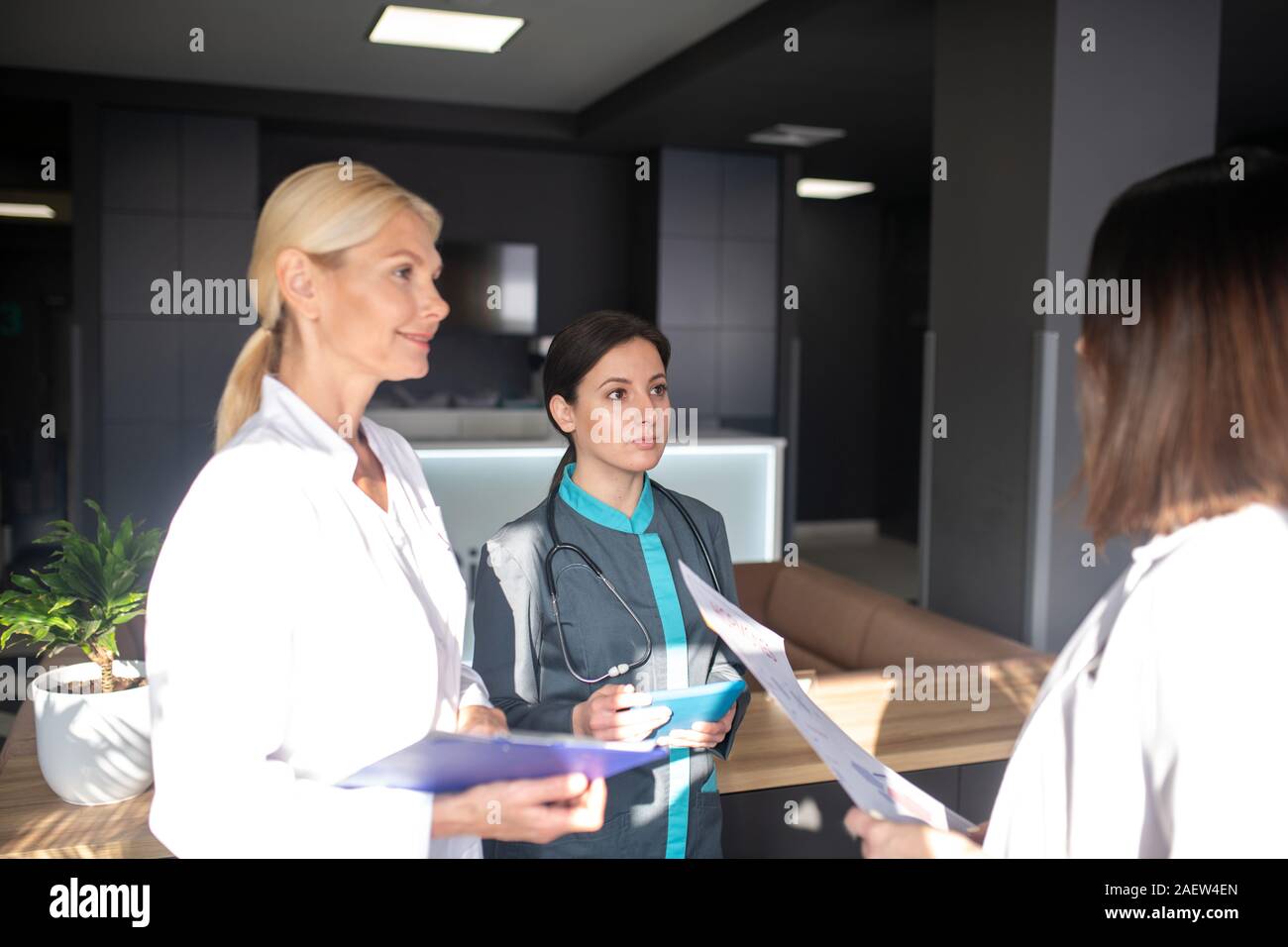 Three female doctors looking good at their work place Stock Photo - Alamy
