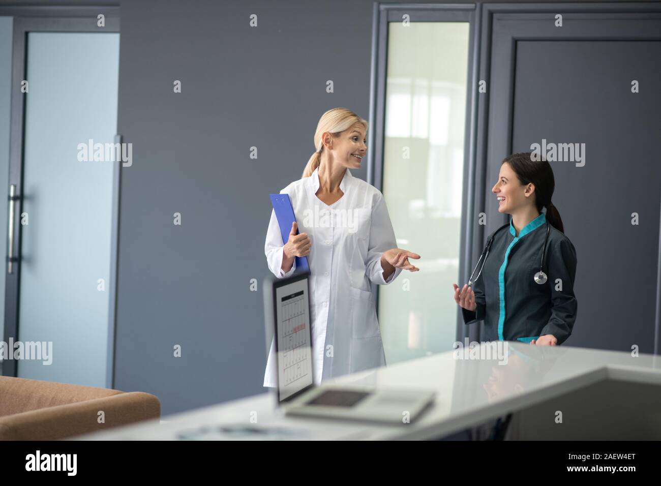 Intern and senior doctor talking in the doctors office Stock Photo - Alamy