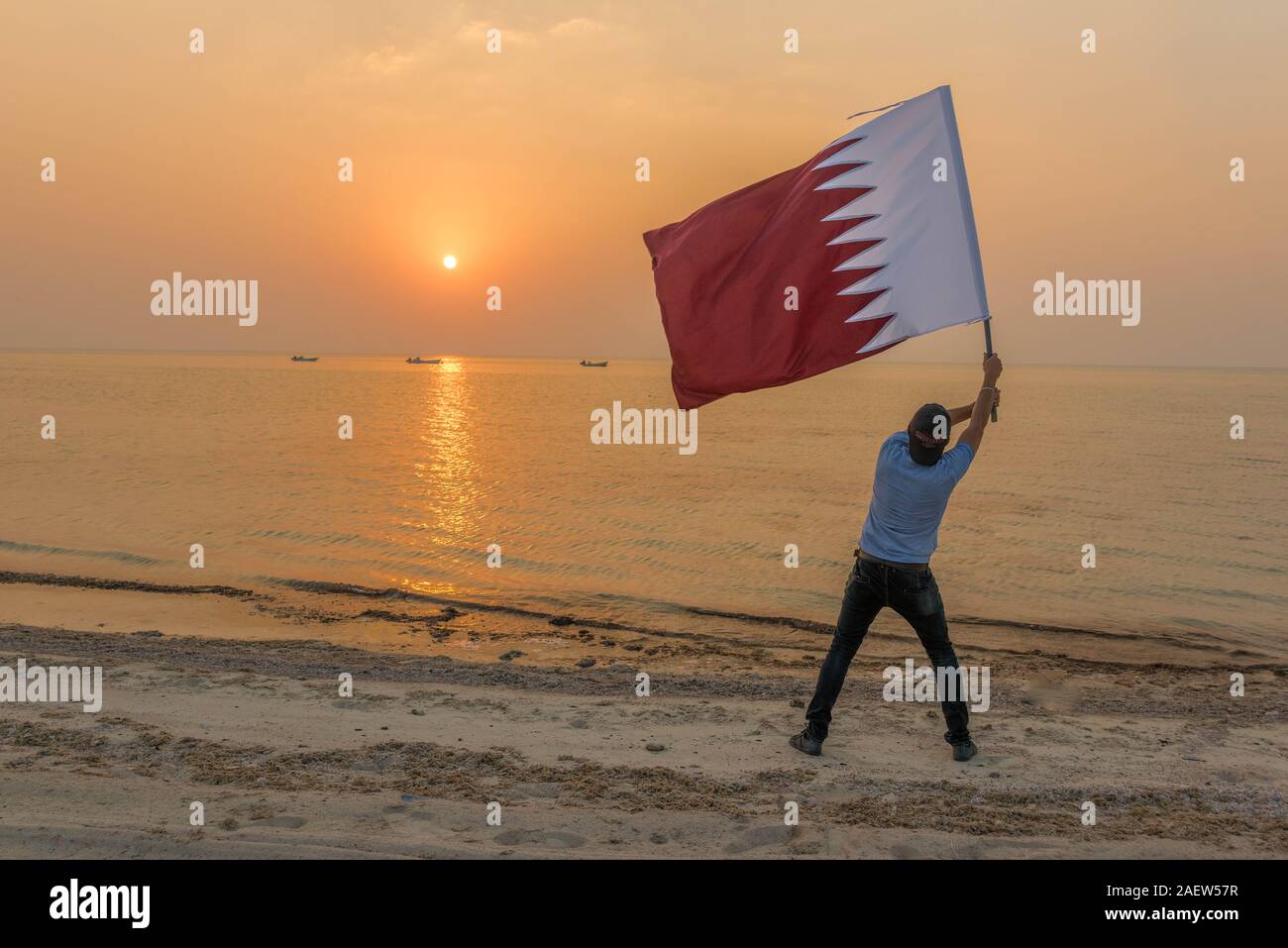 A Man Waving Qatar Flag Stock Photo - Alamy