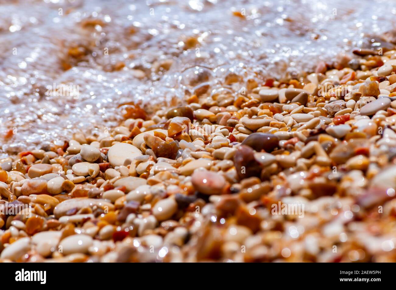 Coastal pebbles washed by Adriatic Sea water waves on Baia delle Zagare ...