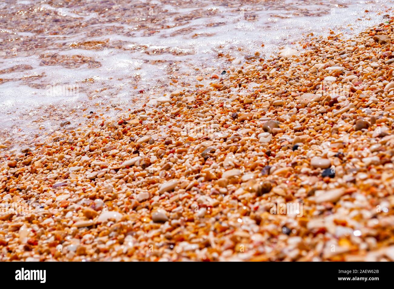 Coastal pebbles washed by Adriatic Sea water waves on Baia delle Zagare ...