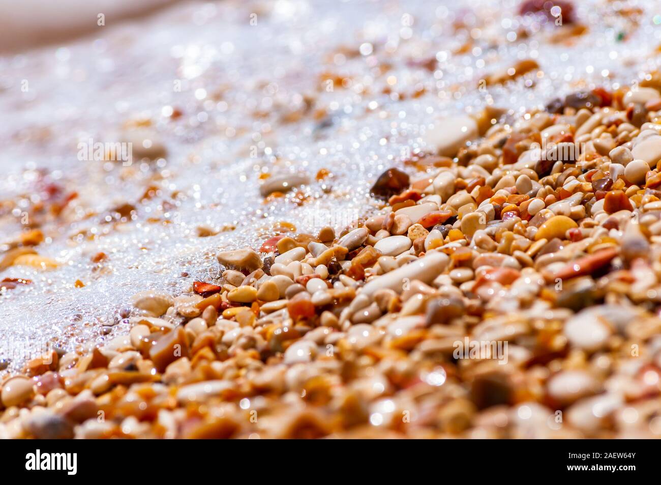 Coastal pebbles washed by Adriatic Sea water waves on Baia delle Zagare ...
